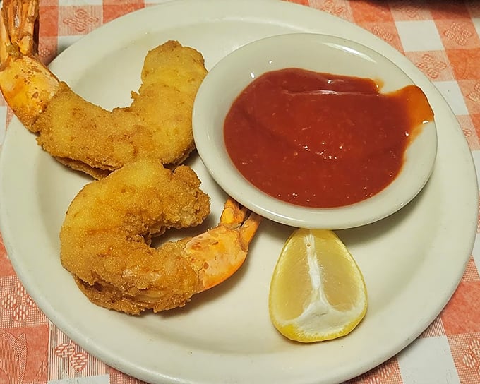 Fried shrimp with cocktail sauce and lemon—simple pleasures executed perfectly, proving that sometimes the classics need no improvement.
