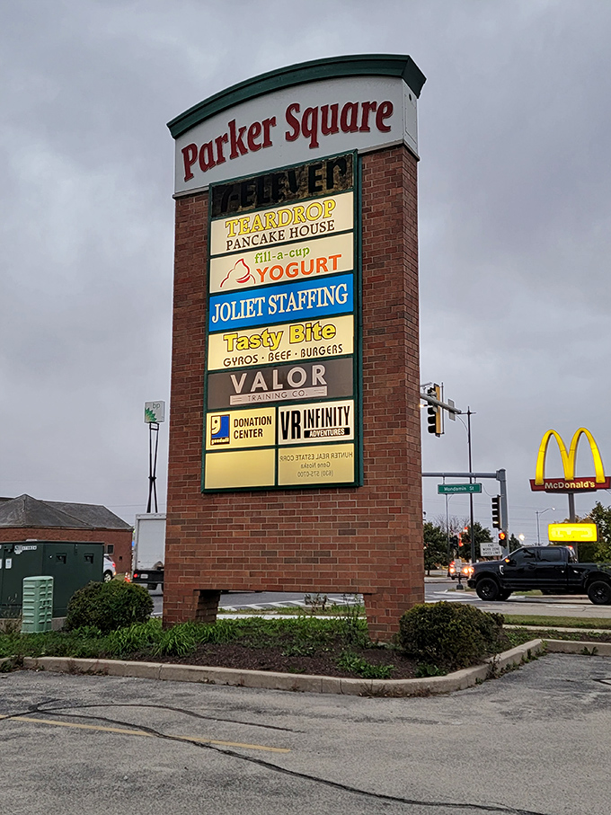 Nestled in Parker Square between pancakes and yogurt, Tasty Bite's humble sign proves that sometimes the best food experiences aren't shouting for attention—they're earning it.