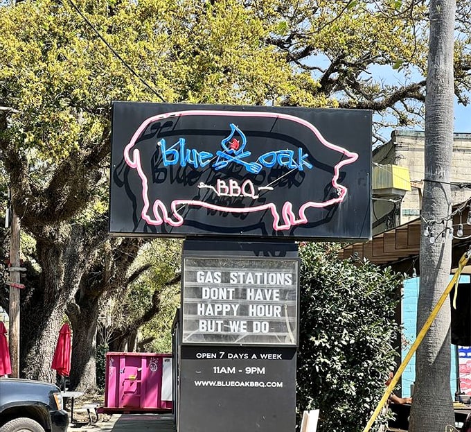 The neon pig sign glows like a barbecue lighthouse, guiding hungry travelers to a port of smoky salvation in the heart of New Orleans.