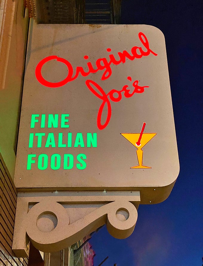By night, the Original Joe's sign transforms into a glowing promise that inside these walls, you'll find "Fine Italian Foods" and perhaps, a perfect martini.