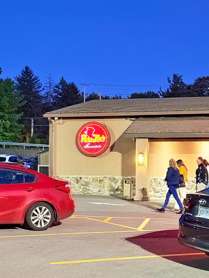 The illuminated sign serves as a beacon for hungry travelers, like a lighthouse guiding ships to the safe harbor of good pasta.