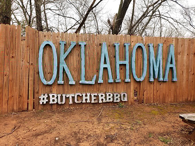 This wooden fence proudly proclaims its Oklahoma heritage—because great barbecue isn't just food, it's a statement of regional pride and tradition.