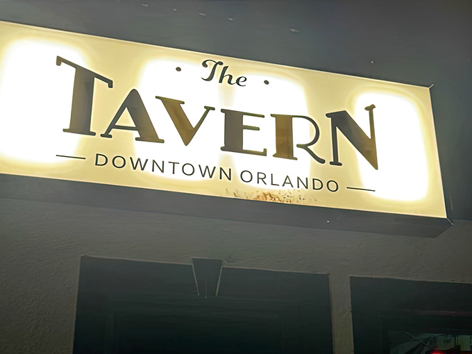 The glowing sign says it all—The Tavern Downtown Orlando, your new favorite spot you didn't know you were looking for.