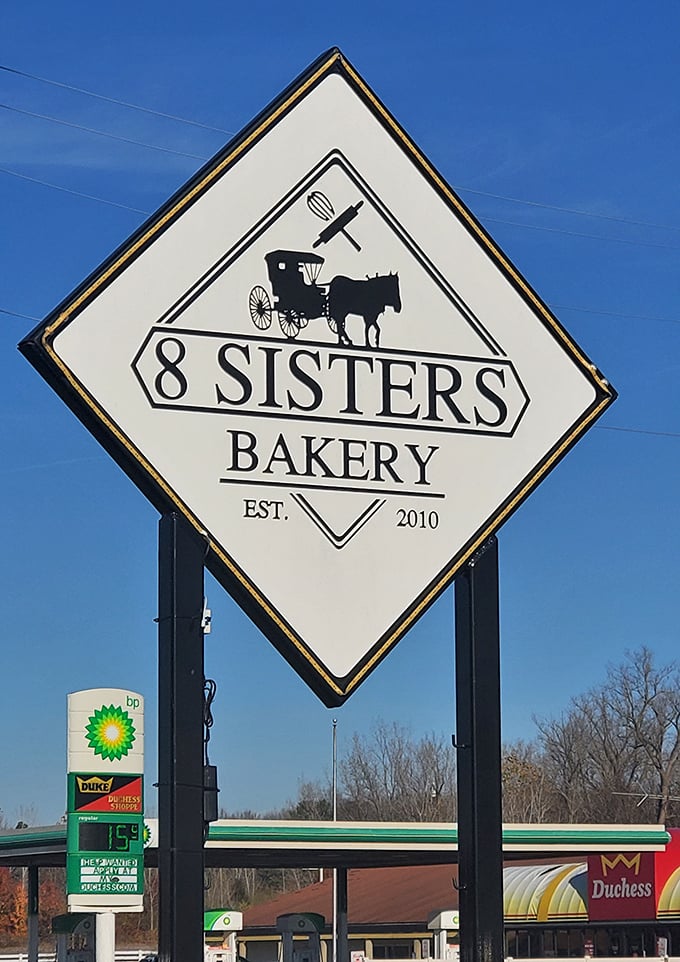 The iconic 8 Sisters sign featuring an Amish buggy and baking tools – a roadside promise of tradition and taste worth stopping for.