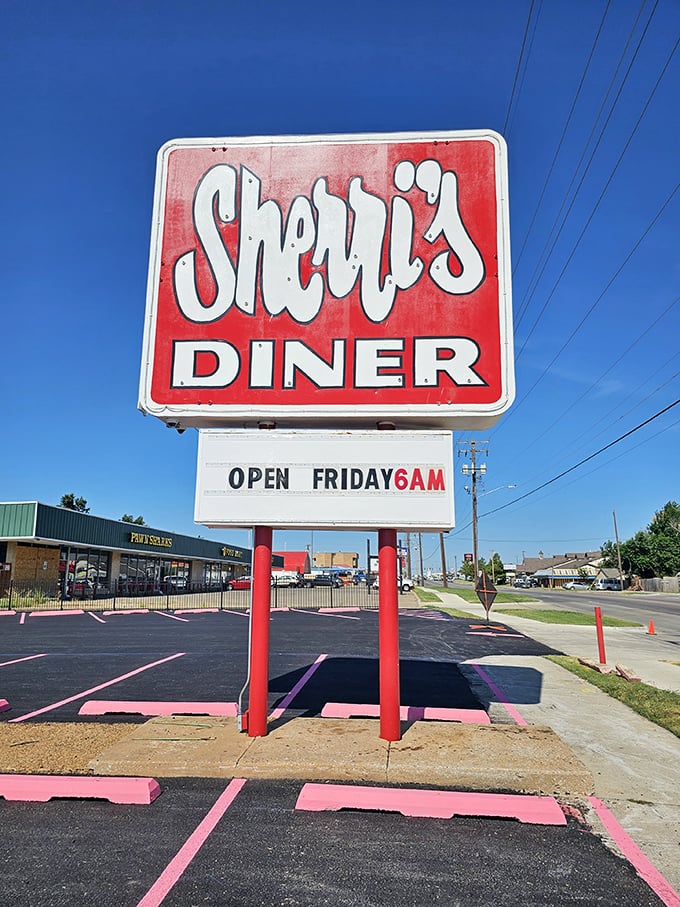 The classic red and white sign stands tall against Oklahoma's blue sky—a beacon for breakfast pilgrims seeking hash brown salvation.