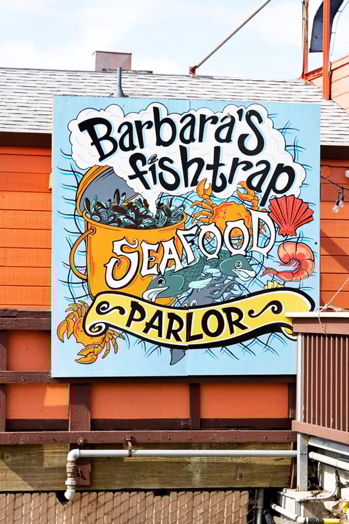 The whimsical sign promises seafood adventures within—like a storybook cover that hints at the delicious tales waiting to be told inside.