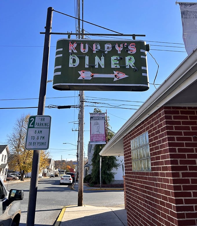 The iconic green Kuppy's sign has guided hungry travelers for generations, a neon north star for those seeking authentic diner delights.