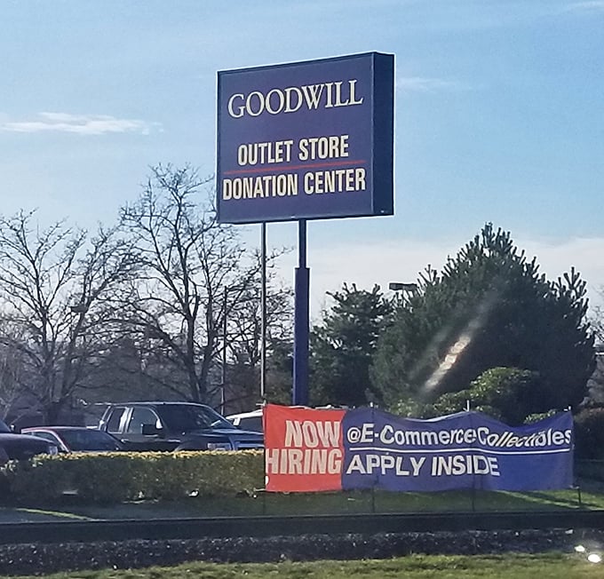 The siren call of secondhand salvation. This sign doesn't just advertise a store—it announces an adventure where $27 fills a cart.