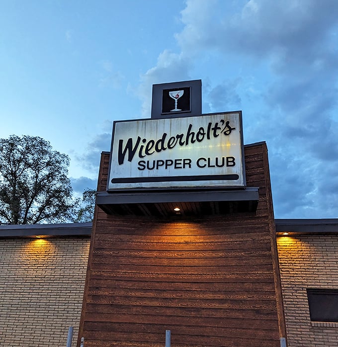 As dusk falls, the Wiederholt's sign glows like a North Star for hungry travelers. That martini icon isn't just a logo—it's a promise of good times ahead.