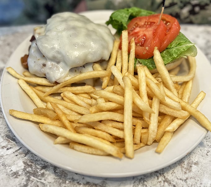 A burger that doesn't need a fancy pedigree, just the basics done right. That melty cheese blanket is tucking in all the flavor for a proper nap.
