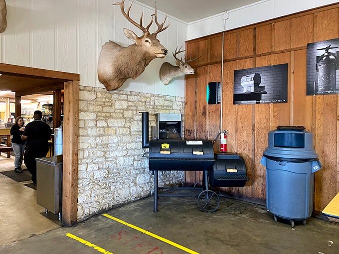 Where the magic happens – a smoker that's witnessed more barbecue history than most of us will ever know, flanked by deer mounts and limestone walls.