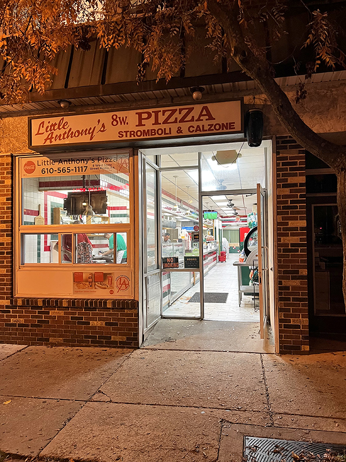 As night falls, Little Anthony's warm glow invites you in from the cold—a timeless scene that's played out on this street corner for years.