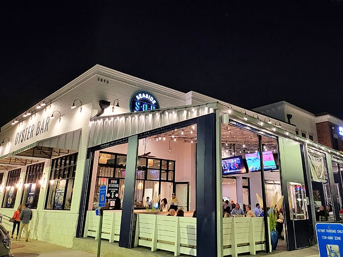 By night, Seaside Oyster Bar transforms into a glowing oasis of culinary delights – like a lighthouse guiding hungry souls to seafood salvation.