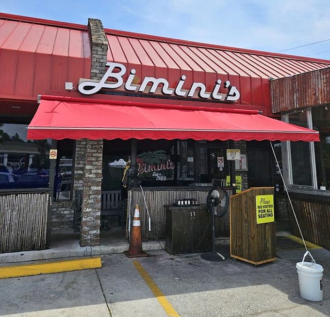 The red awning and stone facade – seafood architecture at its finest. No pretension, just a building focused on getting you to the good stuff inside.