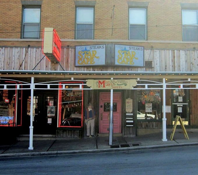 The storefront stands as a beacon of hope for hungry travelers—those blue "STEAKS" signs might as well say "SALVATION" for the famished.