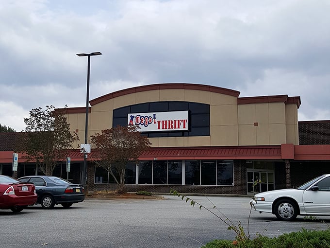 The exterior view on a cloudy day reveals Mega Thrift in all its glory—a cathedral of consignment commanding its corner of Winston-Salem.