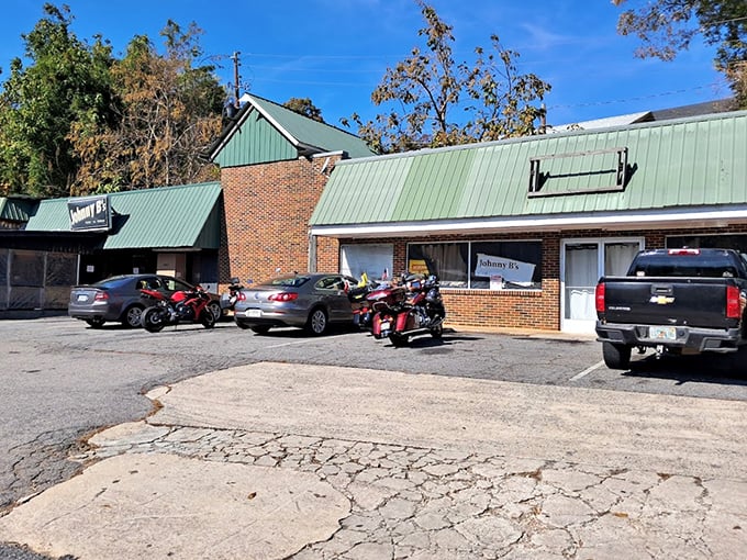 A parking lot filled with cars and motorcycles—universal symbols that something worth stopping for awaits inside those brick walls.