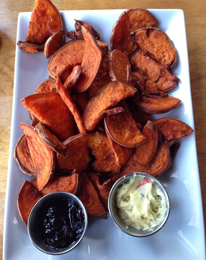 Sweet potato fries that achieve the impossible – crispy exterior, pillowy interior, and served with dipping sauces that make you forget regular potatoes exist.