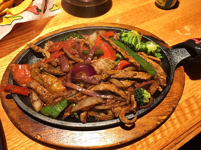 Sizzling fajitas that announce their arrival before you see them. The cast iron skillet isn't just cooking—it's performing a one-pan show.