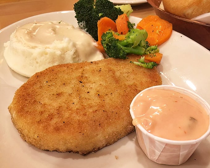 The turkey steak—golden, crisp, and served with sides that know their supporting role—proves that poultry can be the star of any plate.