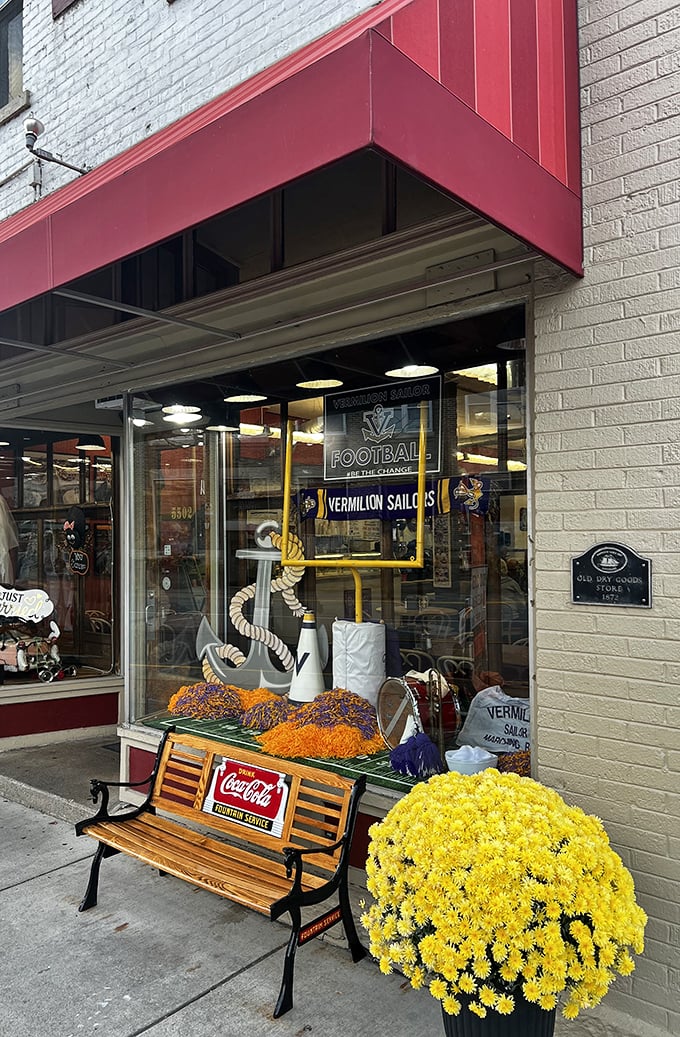 Outside, a Coca-Cola bench invites passersby to pause and enjoy Vermilion's charm—yellow mums adding a splash of seasonal color.