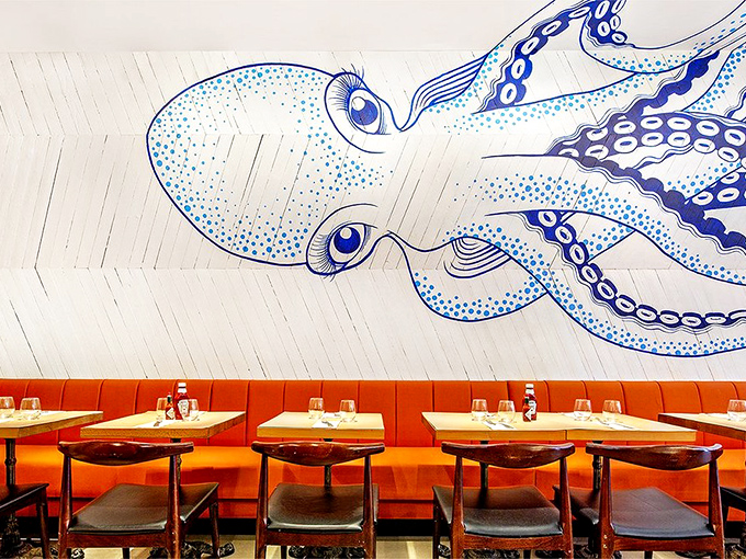 The octopus mural isn't just decoration—it's practically a dining companion, its watchful eyes and flowing tentacles setting the perfect undersea mood.