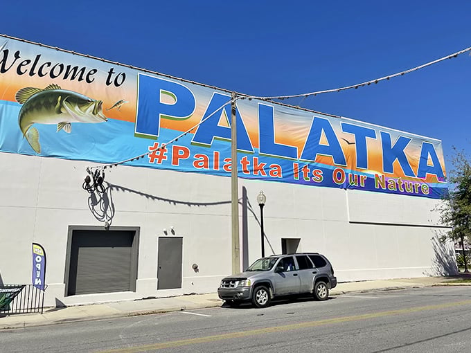 The "Welcome to Palatka" mural celebrates the town's fishing heritage with vibrant colors that pop against the clear blue Florida sky.