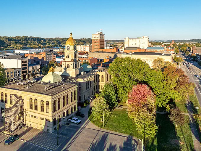 Huntington's aerial view reveals a city nestled between rolling hills and river, with autumn trees adding splashes of color to the urban grid.