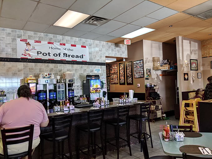 "Home of the Pot of Bread" isn't just a sign—it's a promise. The counter seating offers front-row tickets to the breakfast show.