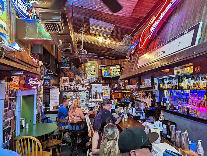 The bar area is a museum of memories—every inch covered with memorabilia, creating the perfect backdrop for cold drinks and warm conversations.
