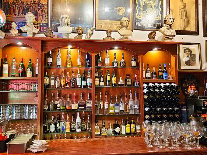 The bar doesn't just stock bottles—it curates liquid history beneath the watchful gaze of classical busts, ready to complement your operatic dining experience.