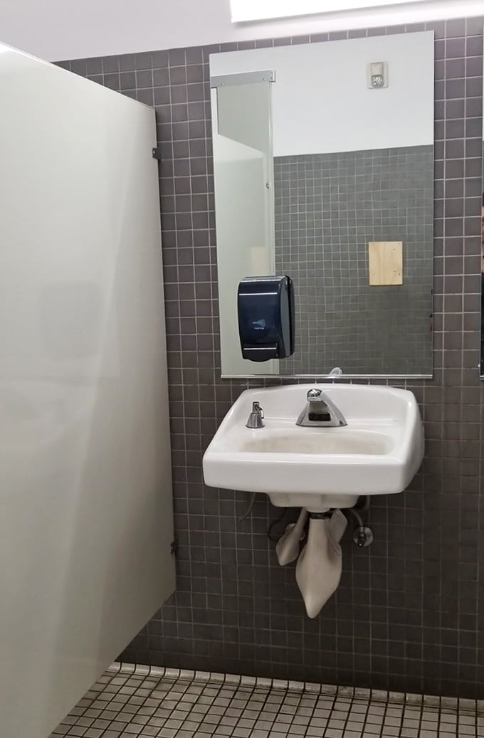 Even the restrooms maintain that no-frills warehouse aesthetic. When nature calls during your treasure hunt, Goodwill answers with utilitarian charm.