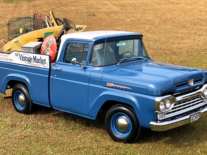 The market's vintage blue Ford pickup, loaded with treasures, serves as the perfect mascot for this haven of historical finds.