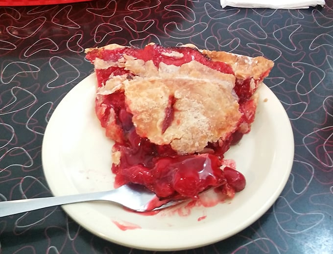Cherry pie with that perfect balance of sweet and tart—the kind that makes you consider ordering a second slice immediately.
