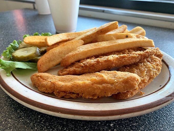 These chicken strips aren't just fried – they're transformed into golden-brown wands of crispy magic that make adults forget they ever outgrew the kids' menu.