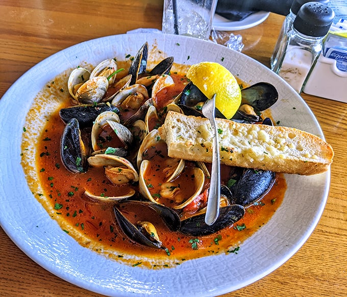 A symphony of shellfish swimming in tomato-saffron broth—this cioppino isn't just dinner, it's an edible treasure hunt with garlic bread for dipping.