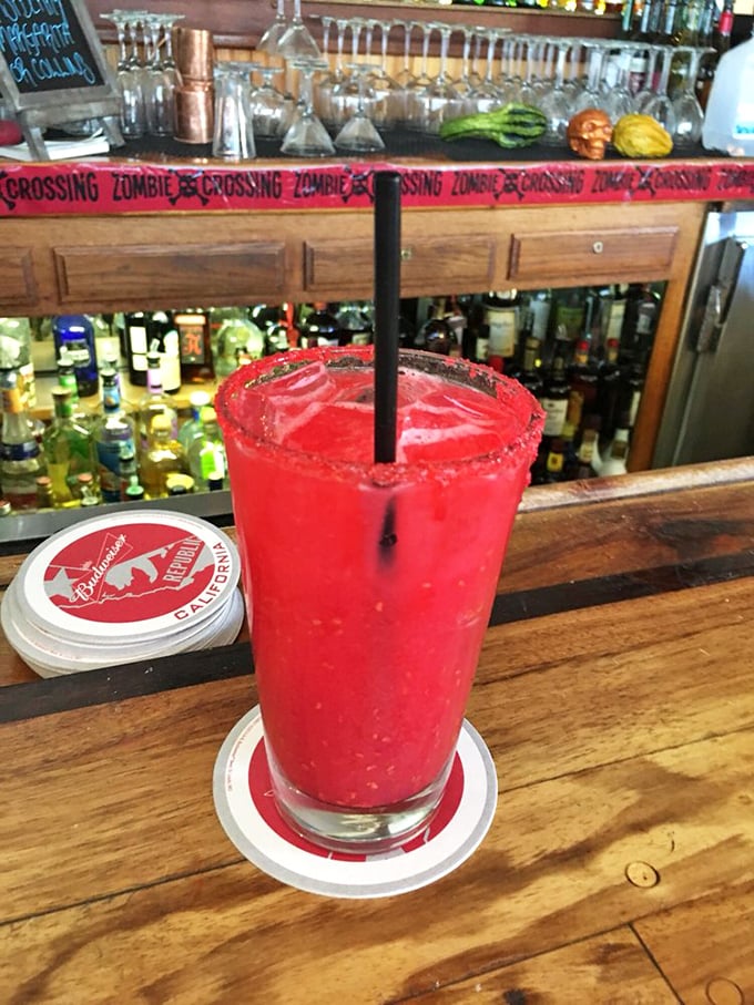 This vibrant red cocktail isn't just a drink—it's liquid vacation in a glass, rimmed with promises of coastal relaxation and sunset views.