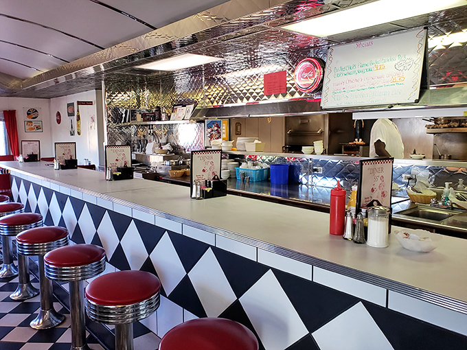 The counter—where solo diners become temporary family, watching short-order ballet performed by cooks who've elevated diner food to an art form.