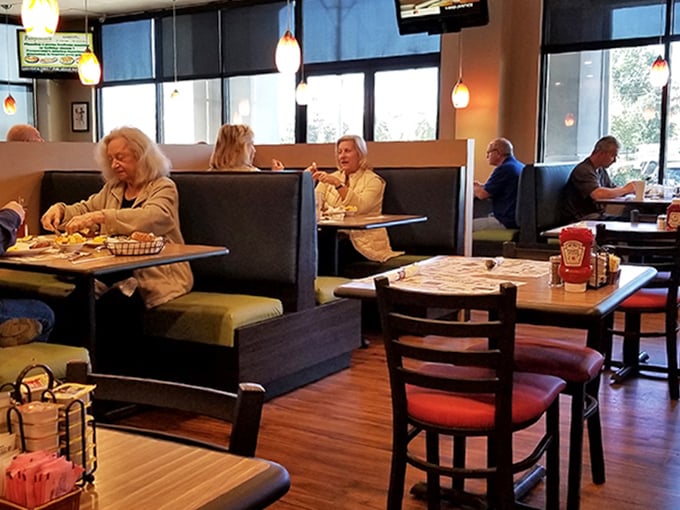 Diners settle into comfortable booths, creating that perfect harmony of conversation, comfort food, and the occasional envious glance at neighboring plates.