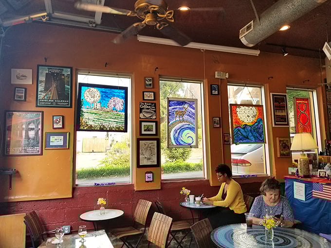 Stained glass windows filter light onto diners lost in conversation—proving that sometimes the best social media is actually just being social over media-worthy food.