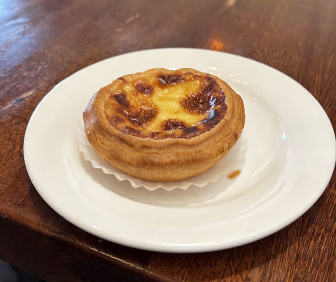 This Portuguese-influenced egg tart doesn't just end a meal—it puts a period at the end of a delicious sentence with caramelized custard punctuation.