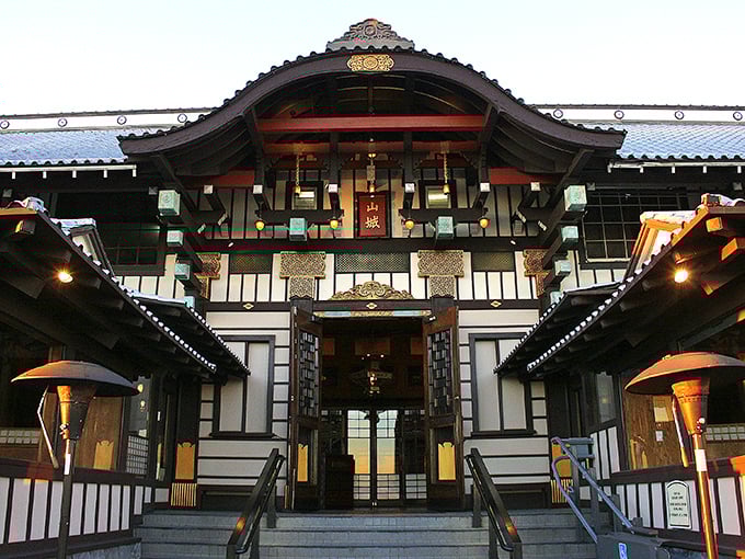 As twilight descends, Yamashiro's illuminated entrance transforms into a beacon of culinary promise above the Hollywood lights.
