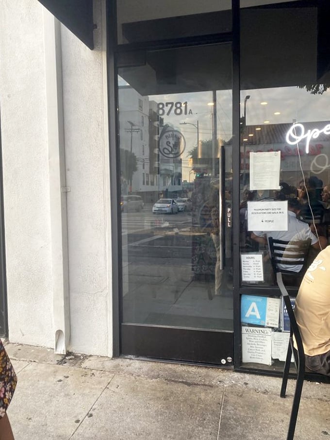 The entrance to pizza paradise is marked with a simple address. No velvet ropes needed when your reputation precedes you.