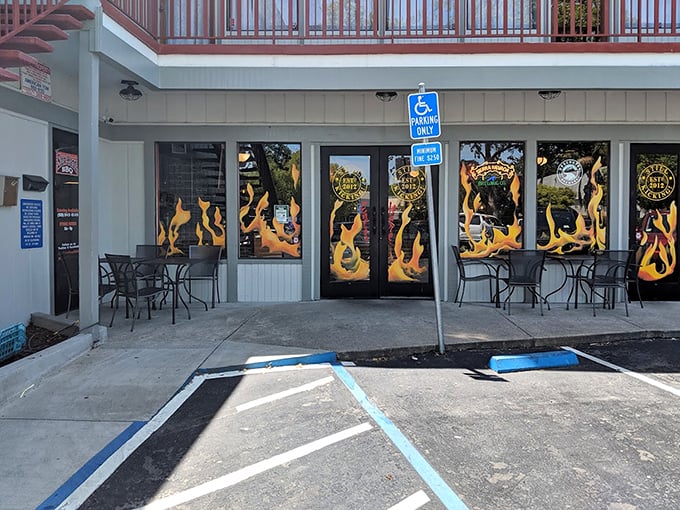 The flame-adorned entrance – a not-so-subtle hint at the smoky delights waiting inside this Pleasant Hill treasure.