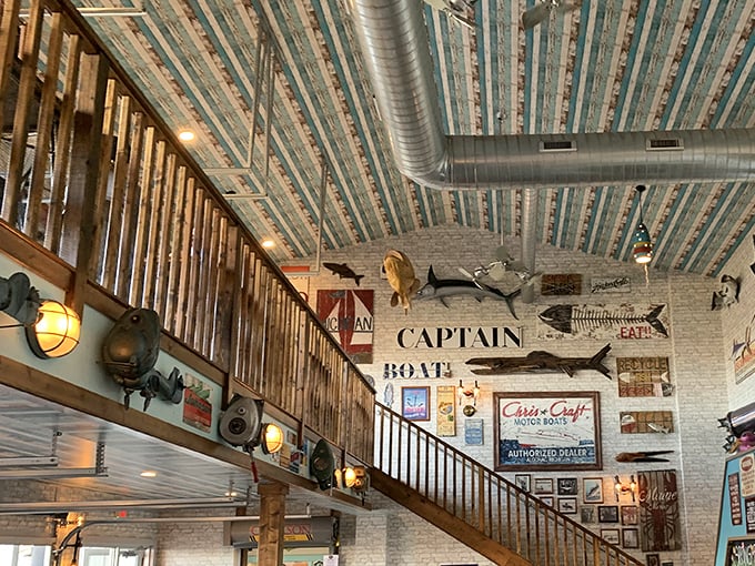 The staircase doesn't just lead upstairs—it's a wooden pathway to more nautical charm, surrounded by the ghosts of fish past.