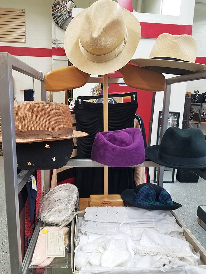 The hat stand: where fedoras, sun hats, and berets wait for their perfect match—because nothing completes a thrift store triumph like the perfect topper.