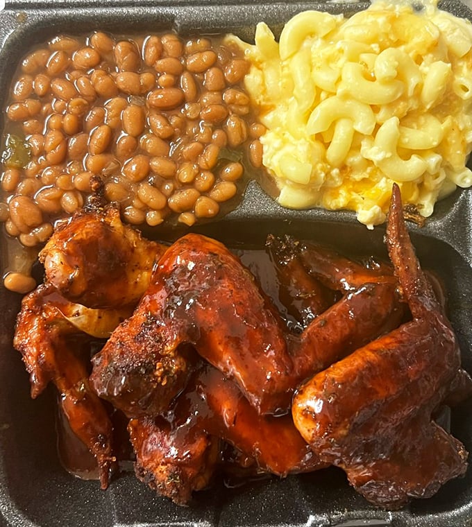 Barbecue wings with that perfect lacquer of sauce, mac and cheese, and beans—a holy trinity that makes you believe in culinary divinity.