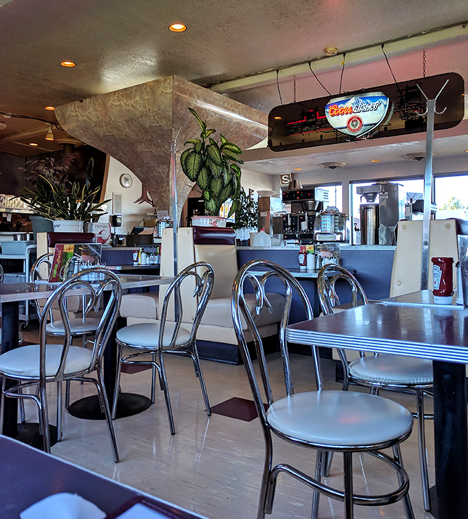Plants, chrome chairs, and that unmistakable diner ambiance – a sanctuary for those seeking authentic comfort food.