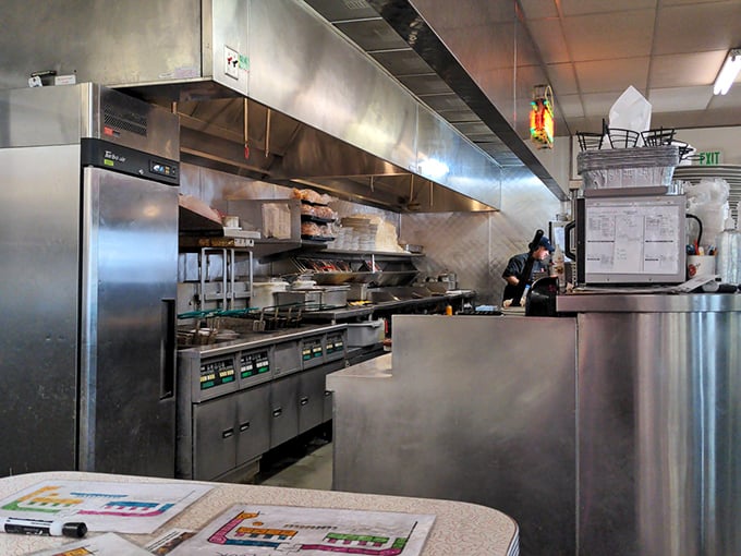 Where the magic happens—a kitchen that's seen more eggs cracked than a chicken farm during an earthquake. Those stainless steel surfaces have stories to tell, most involving butter.