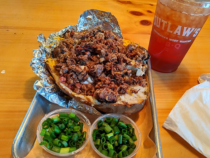 The loaded baked potato – where a humble spud becomes the foundation for a mountain of barbecue excellence. 
